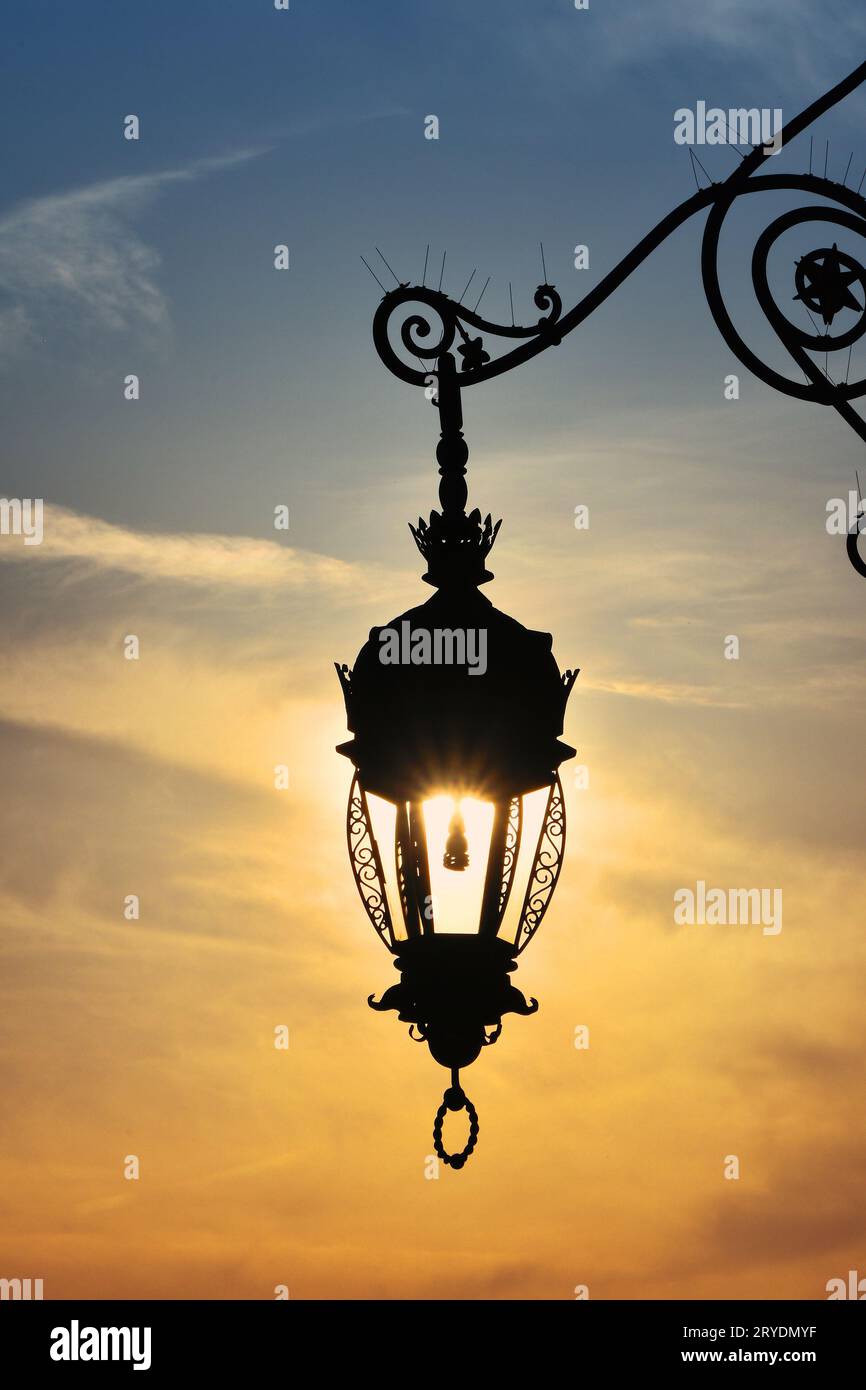 Antique street lamp lantern over sunset sky Stock Photo - Alamy