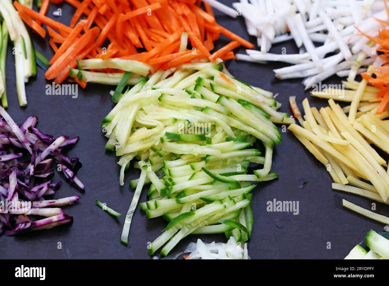 Assorted cut sliced vegetables on cooking board Stock Photo - Alamy