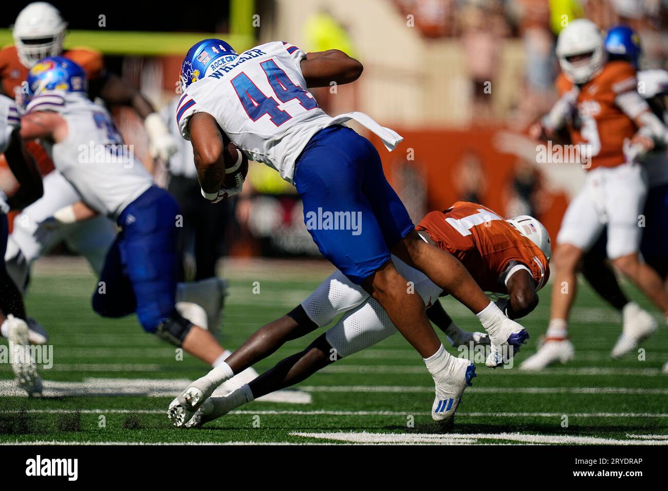 Kansas linebacker Cornell Wheeler (44) is upended by Texas wide ...