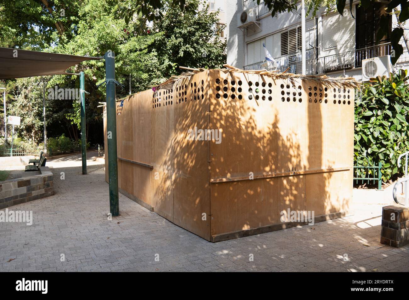 Wooden sukkah in a yard of a residential building in Israeli town ...