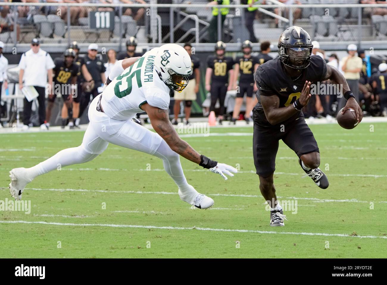 Central Florida quarterback Timmy McClain, right, scrambles for yardage ...