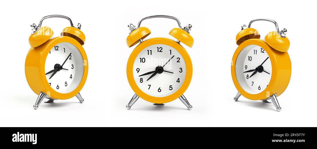 Three yellow alarm clock over white Stock Photo - Alamy