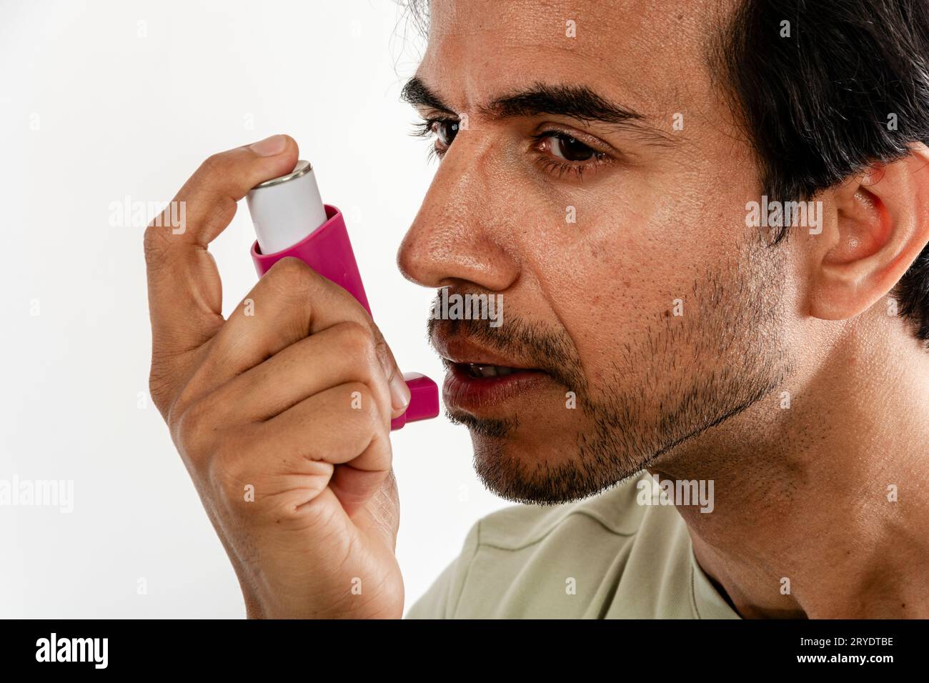 Young man using a respiratory inhaler Stock Photo - Alamy