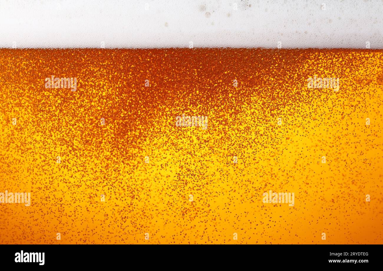 Close up background of beer with bubbles in glass Stock Photo - Alamy