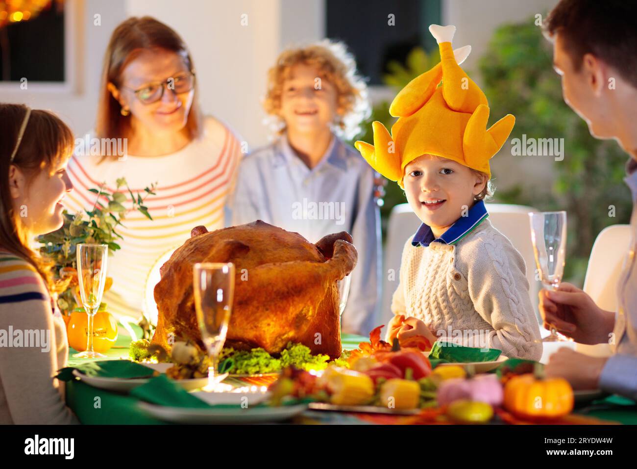 Family at Thanksgiving dinner. Parents, grandparents and kids enjoy ...