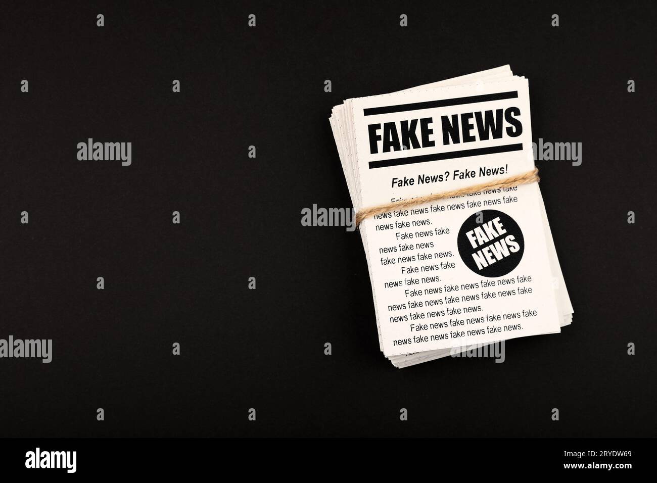 Stack of FAKE NEWS newspapers over black Stock Photo - Alamy