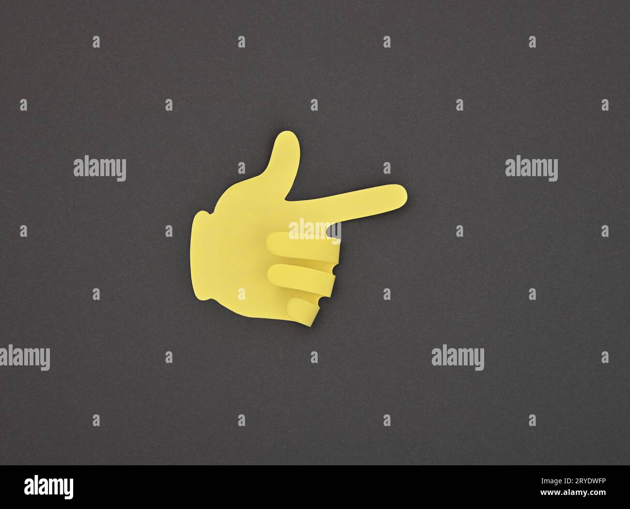 Paper made yellow pointing gesture sticker on grey Stock Photo - Alamy