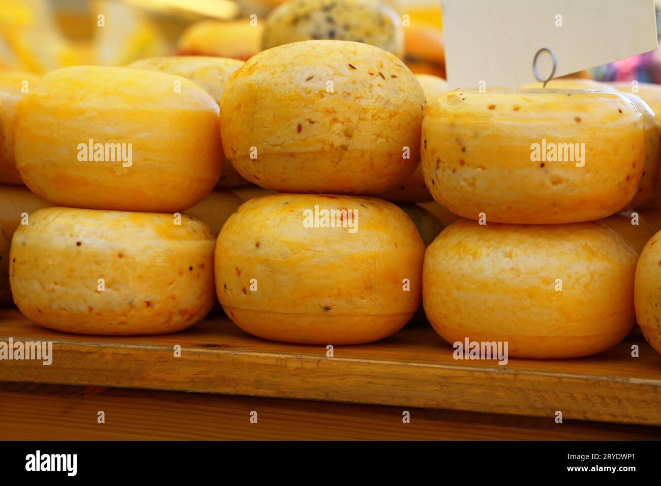Small heads of hard cheese on retail display Stock Photo - Alamy