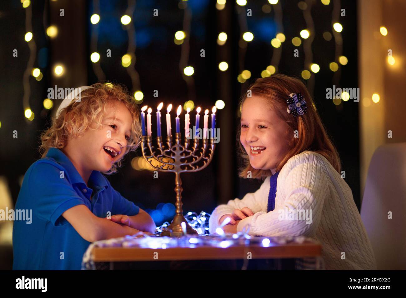Kids celebrating Hanukkah. Jewish festival of lights. Children lighting ...