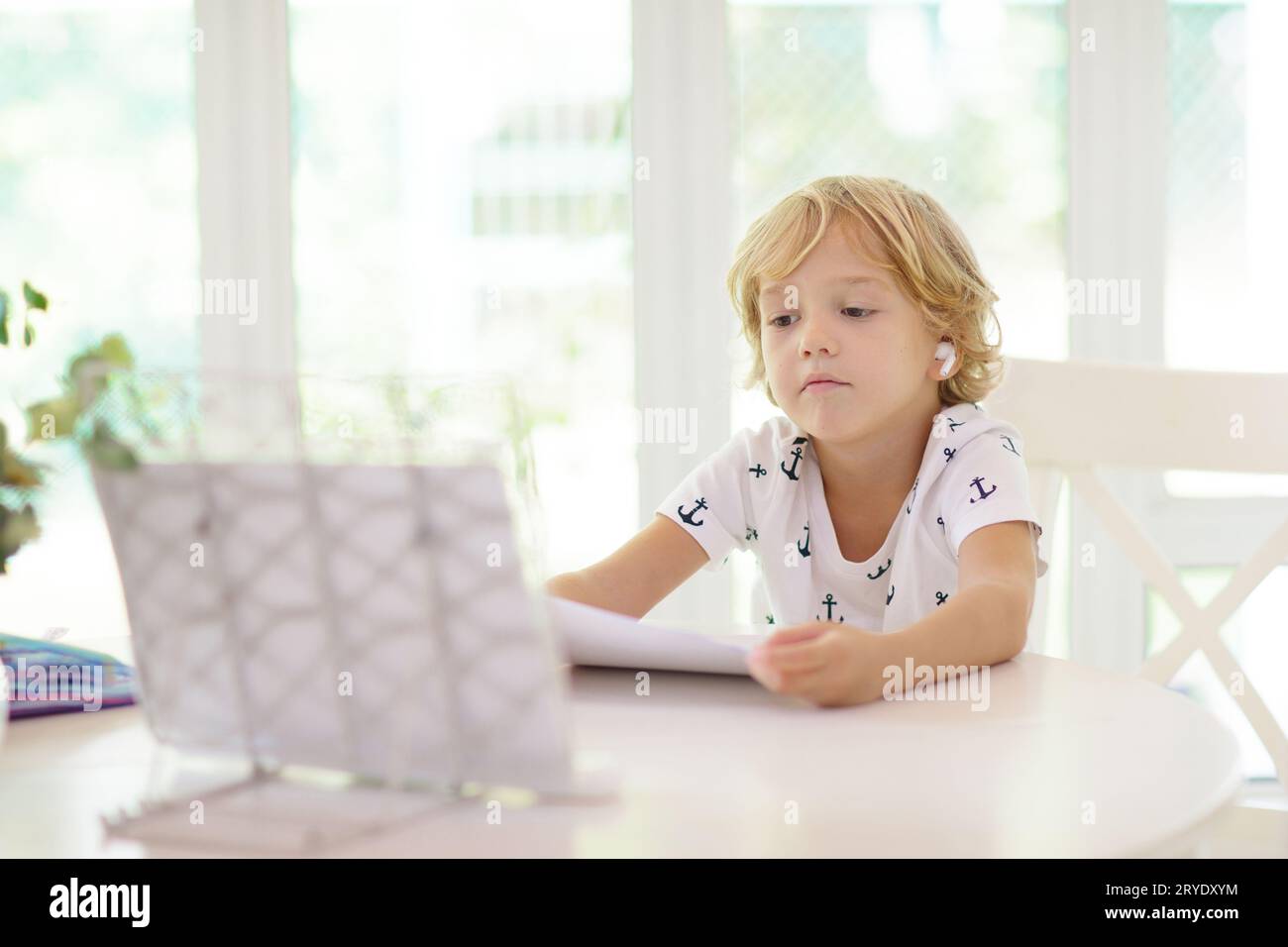 Online remote learning. School kids with computer having video ...
