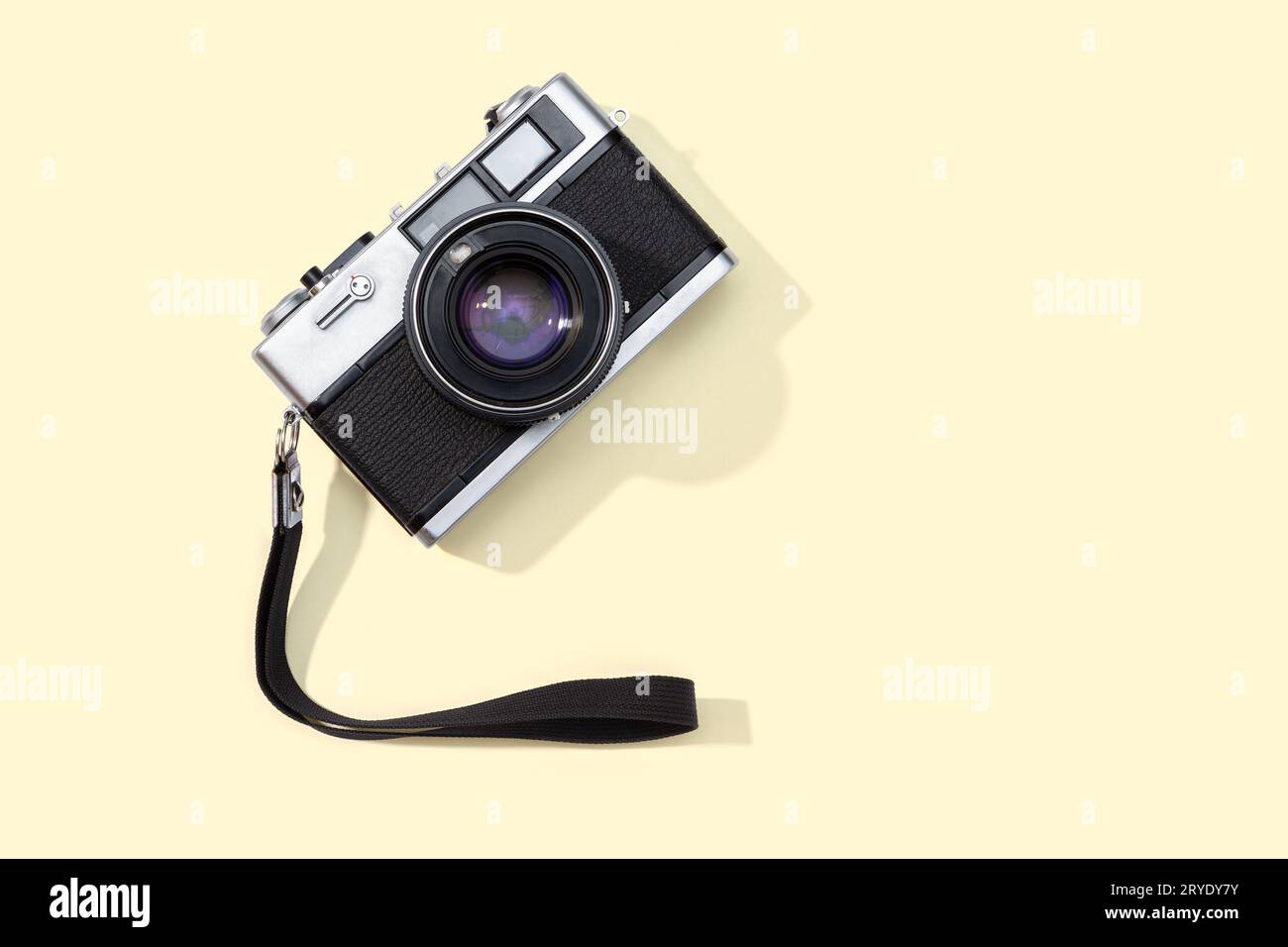 Flat lay film camera isolated on yellow background Stock Photo - Alamy