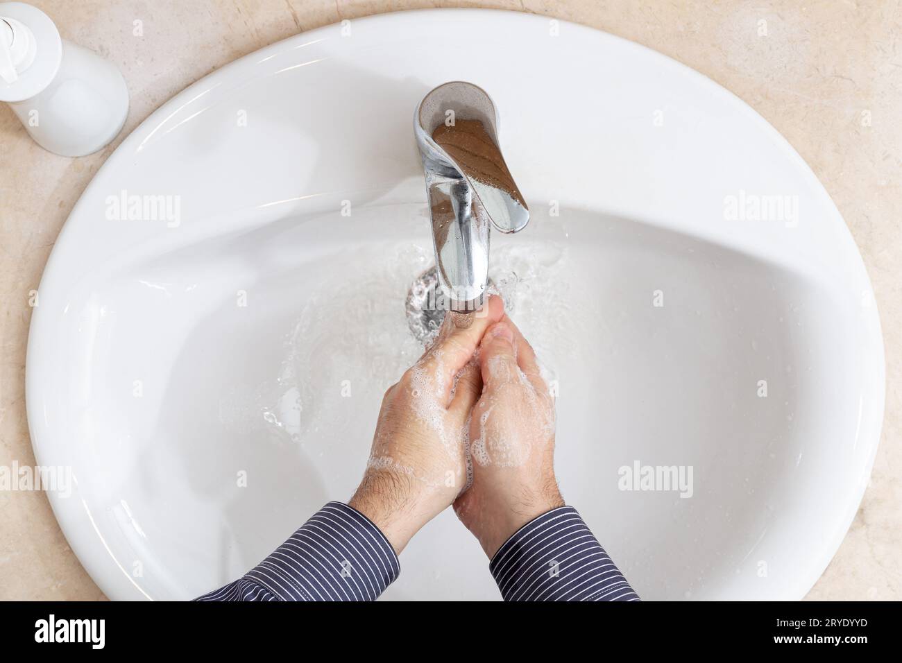 Man washing hands with water and soap on bathroom. Coronavirus ...