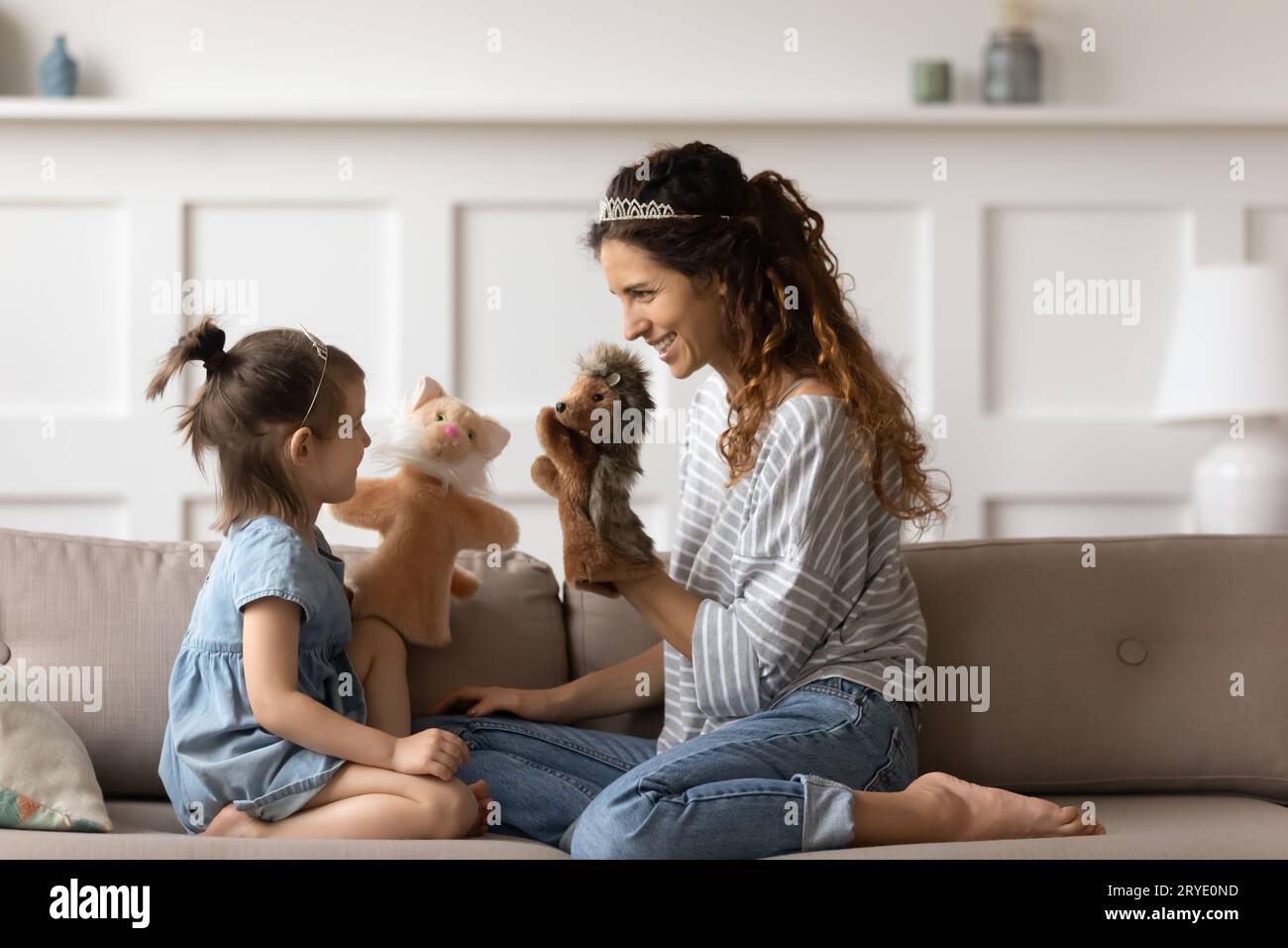 Happy mom playing dolls with excited small daughter Stock Photo - Alamy