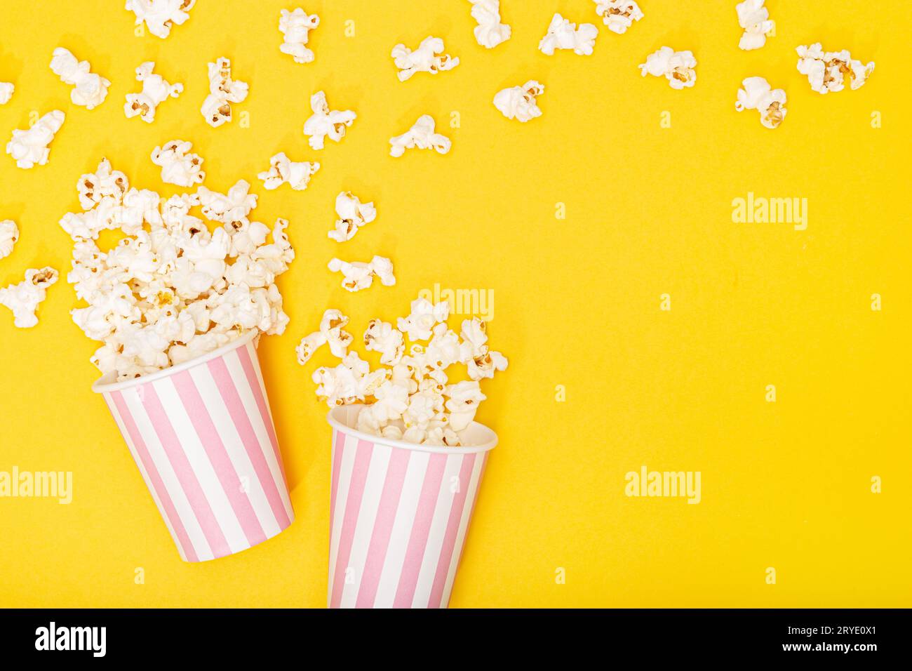 Popcorn bucket on yellow background Stock Photo - Alamy