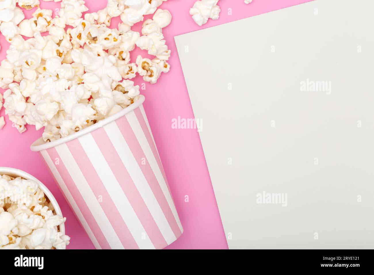 Popcorn bucket and blank sheet on pink background Stock Photo - Alamy