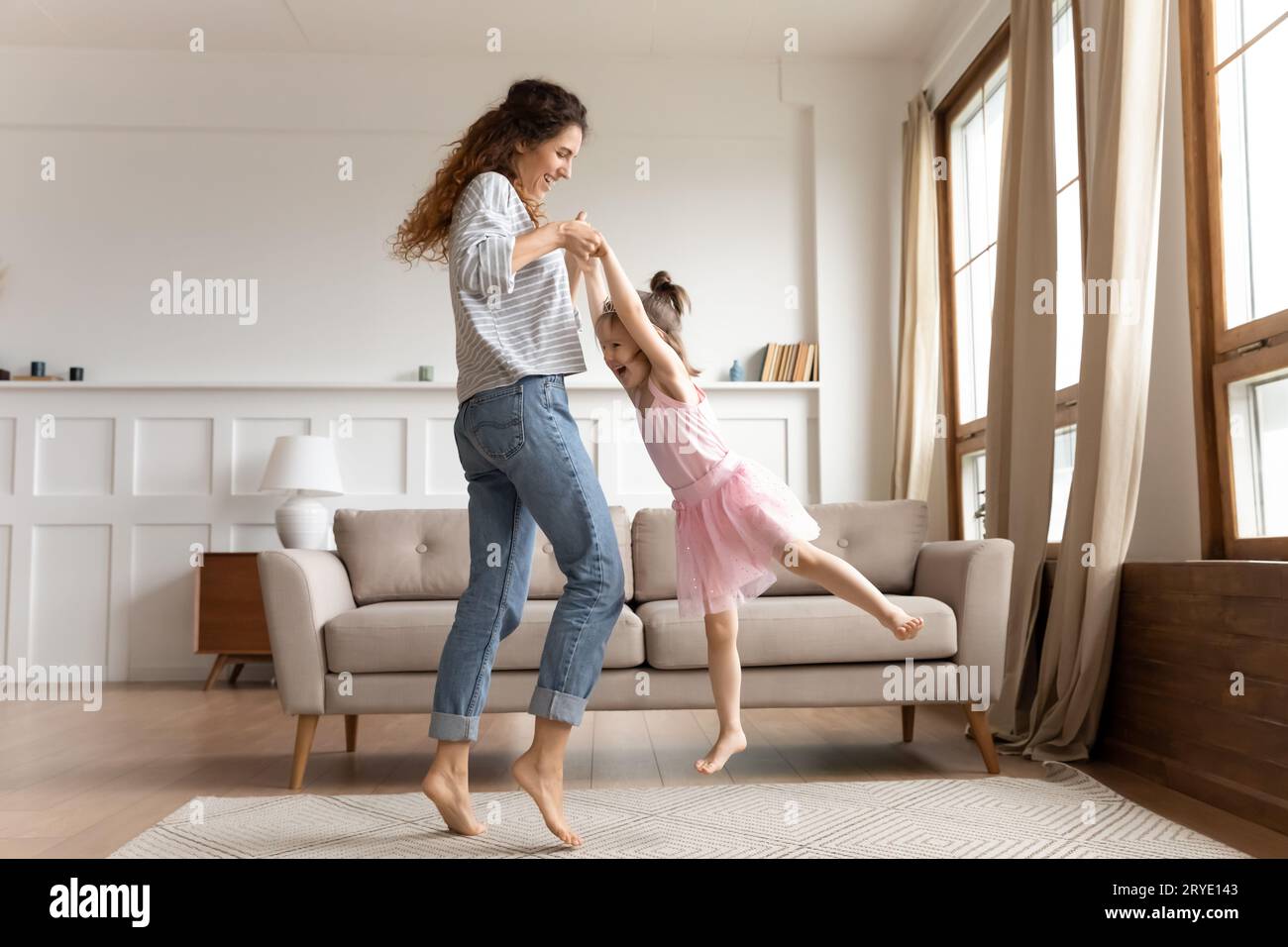 Happy young mum and little daughter dancing at home Stock Photo - Alamy