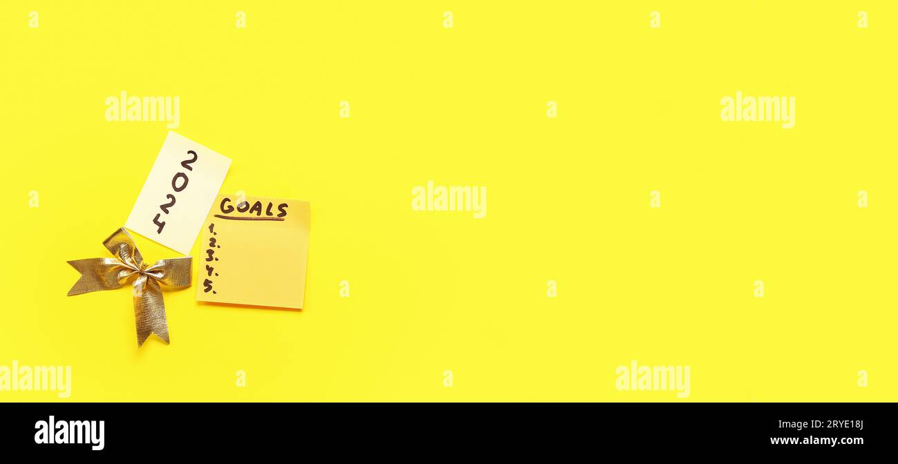 Note papers with to-do list for new year 2024 on yellow background with ...