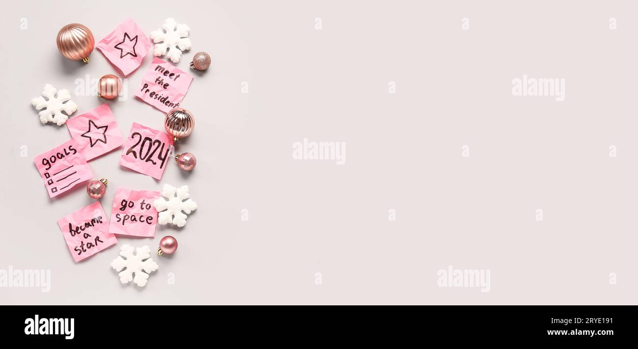 Note papers with written goals for new year 2024 and decor on light ...