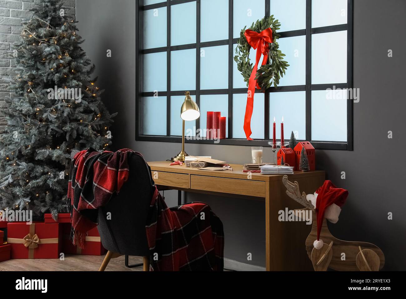 Interior of dark office with workplace, Christmas tree and wreath Stock ...