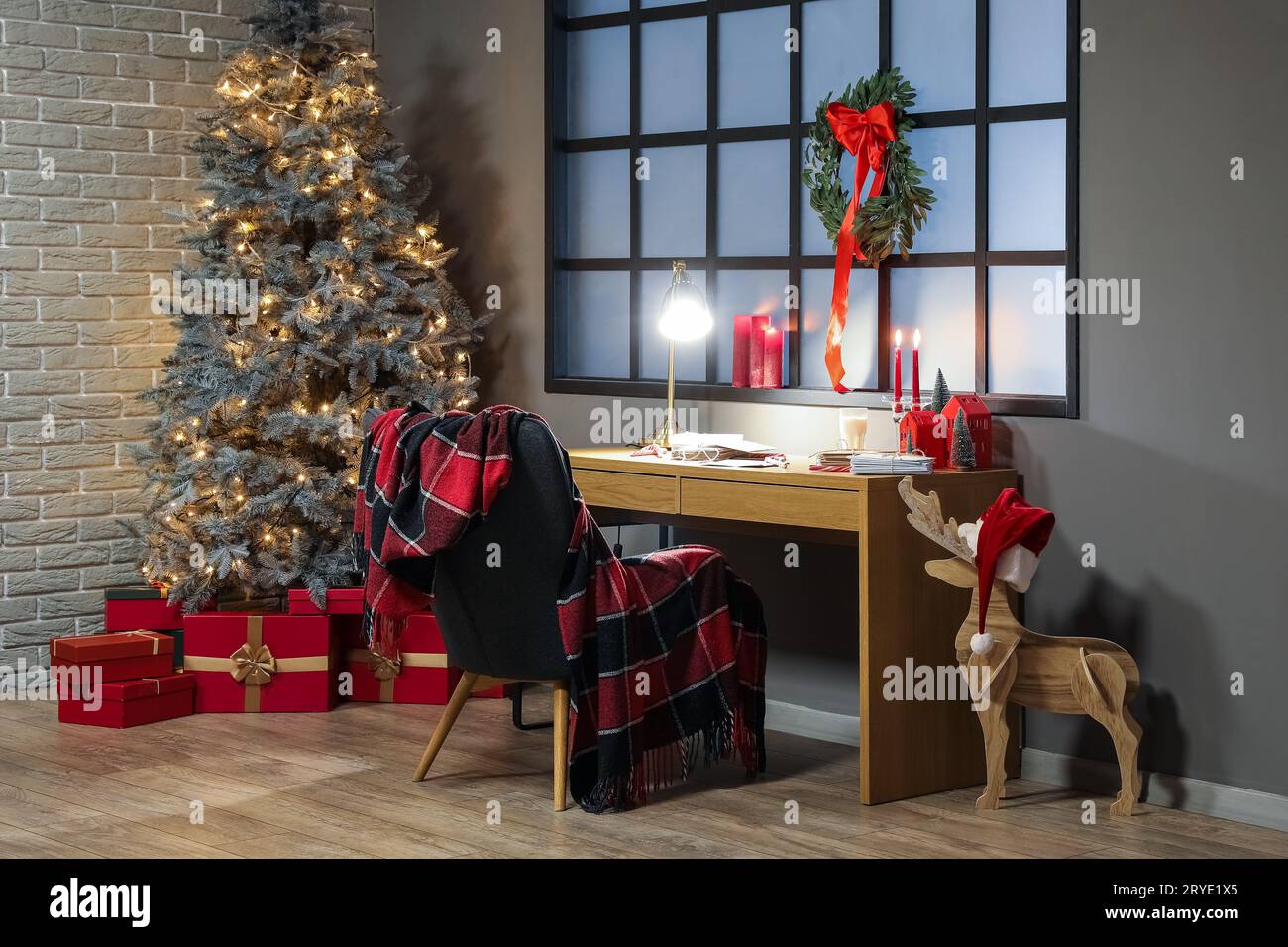 Interior of dark office with workplace, Christmas tree and wreath Stock ...
