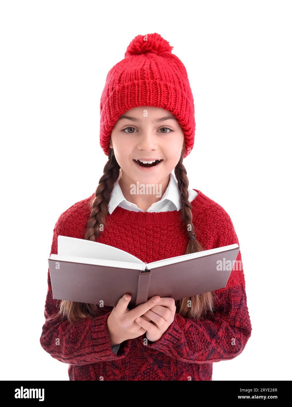 Little girl in winter clothes reading book on white background Stock ...