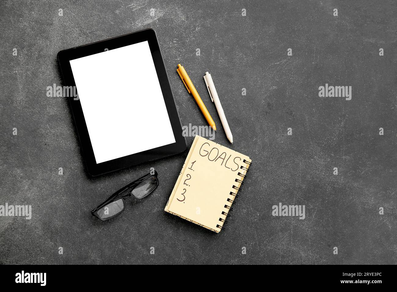 Notebook with empty to do list, tablet and eyeglasses on black grunge ...
