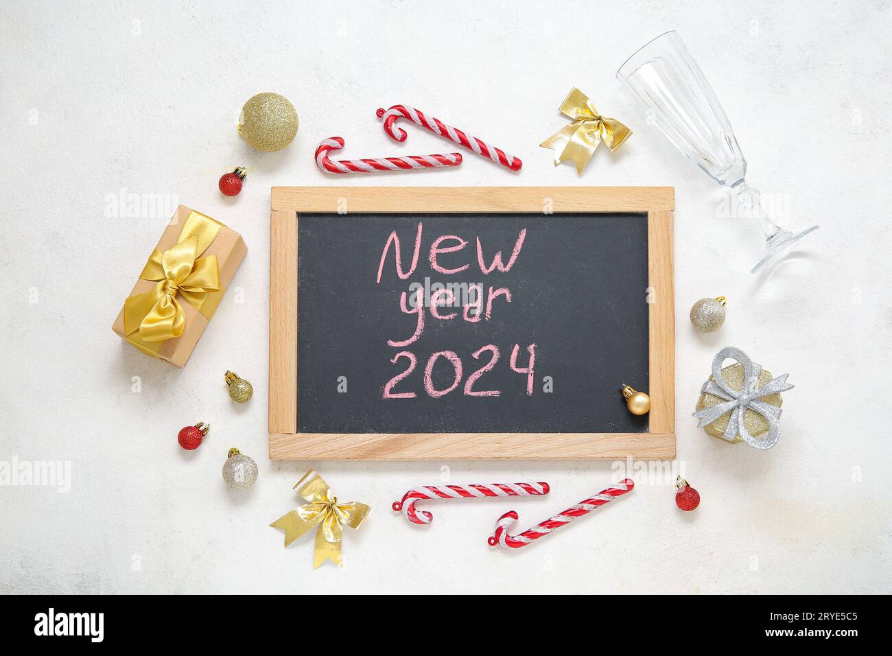 Blackboard with text NEW YEAR 2024, gift boxes and Christmas ...