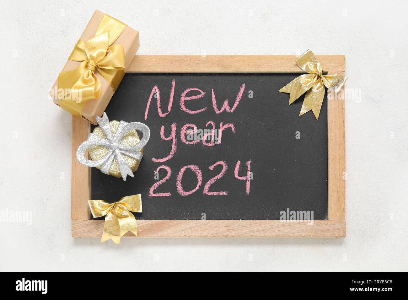 Blackboard with text NEW YEAR 2024, gift boxes and bows on white ...