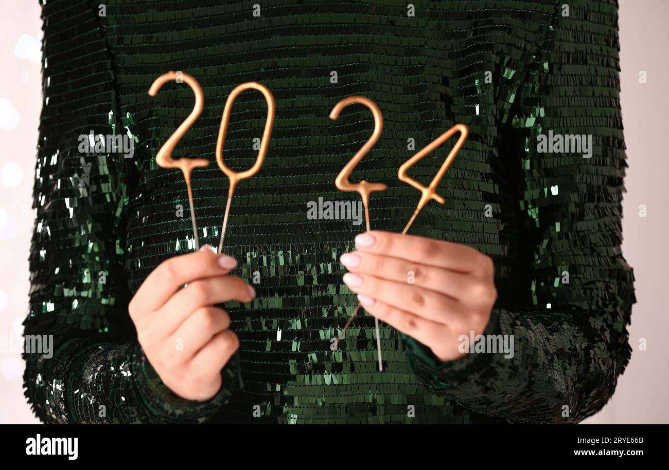 Woman holding golden figure 2024, closeup Stock Photo - Alamy