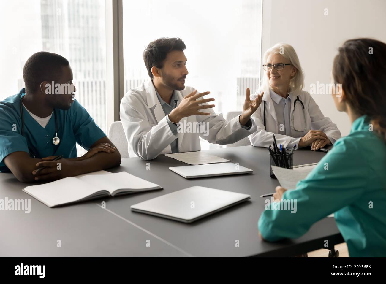 Confident male Indian chief doctor talking to diverse therapists Stock ...