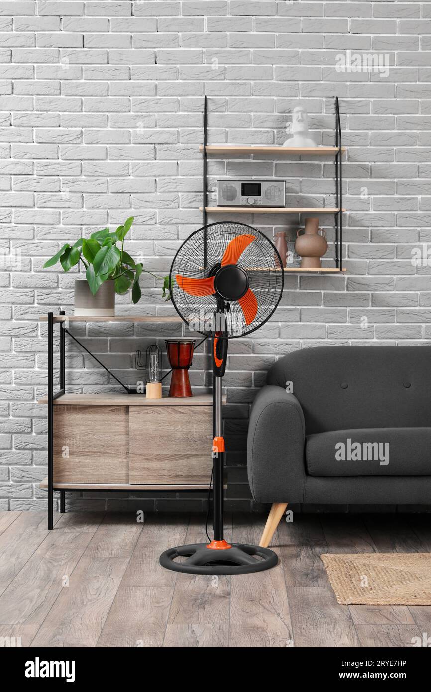 Interior of modern living room with sofa and electric fan Stock Photo ...