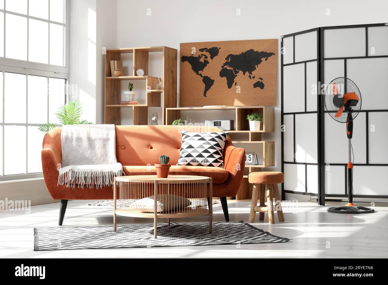 Interior of stylish living room with electric fan, sofa and table Stock ...