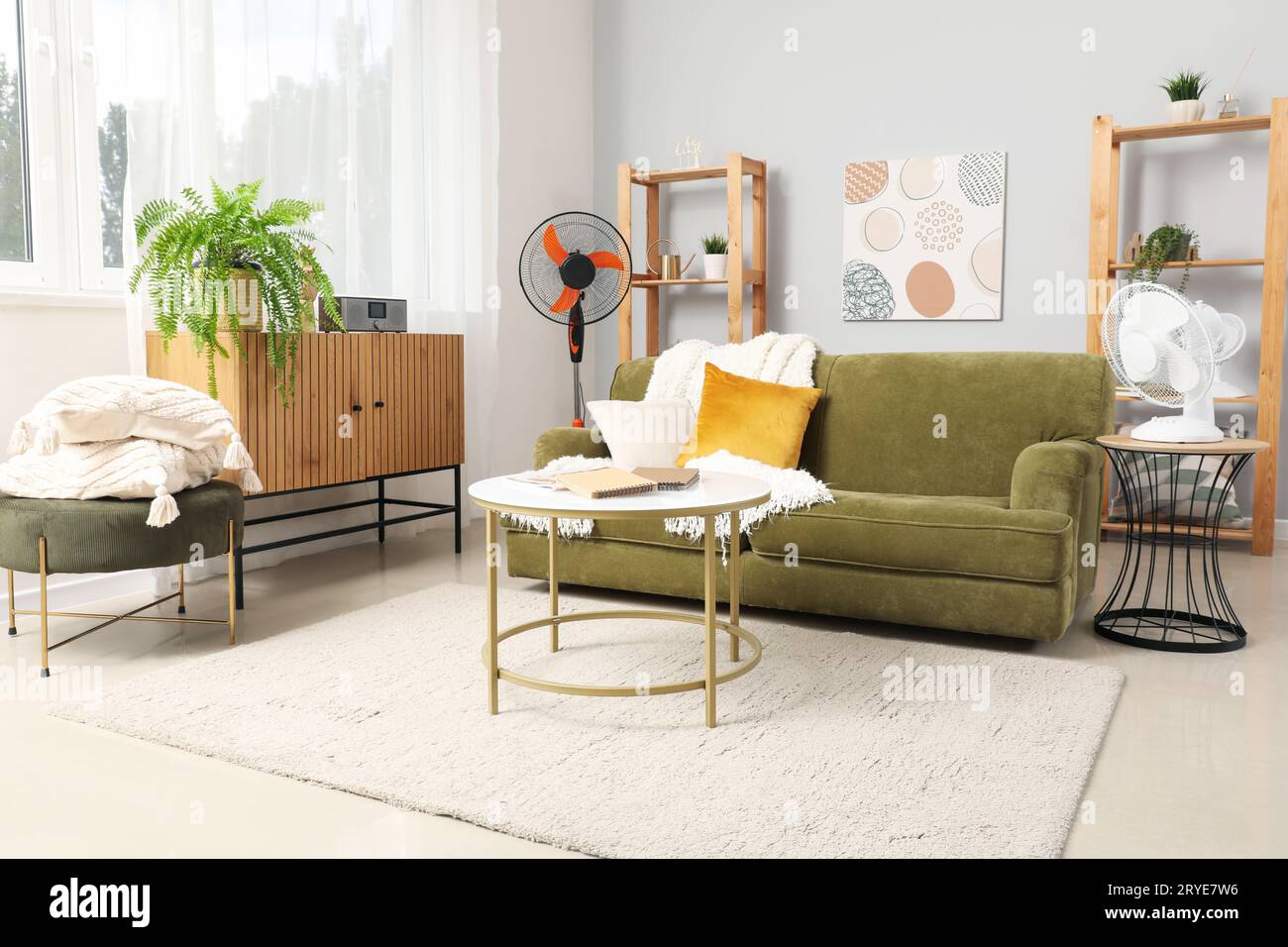 Interior of stylish living room with electric fans and sofa Stock Photo ...