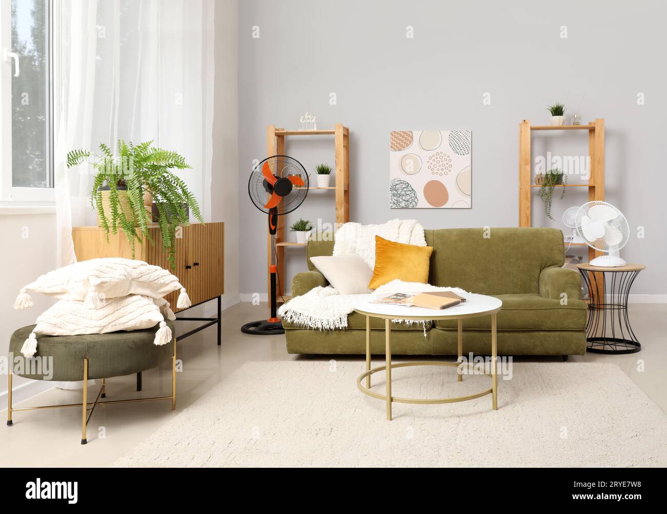 Interior of stylish living room with electric fans and sofa Stock Photo ...