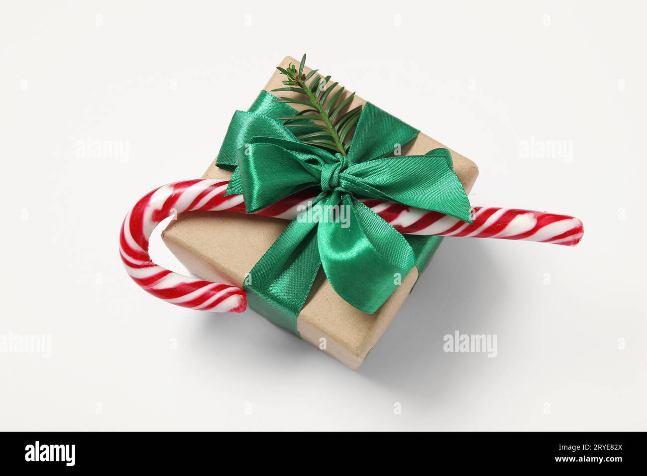 Beautiful gift box with candy cane on white background Stock Photo - Alamy