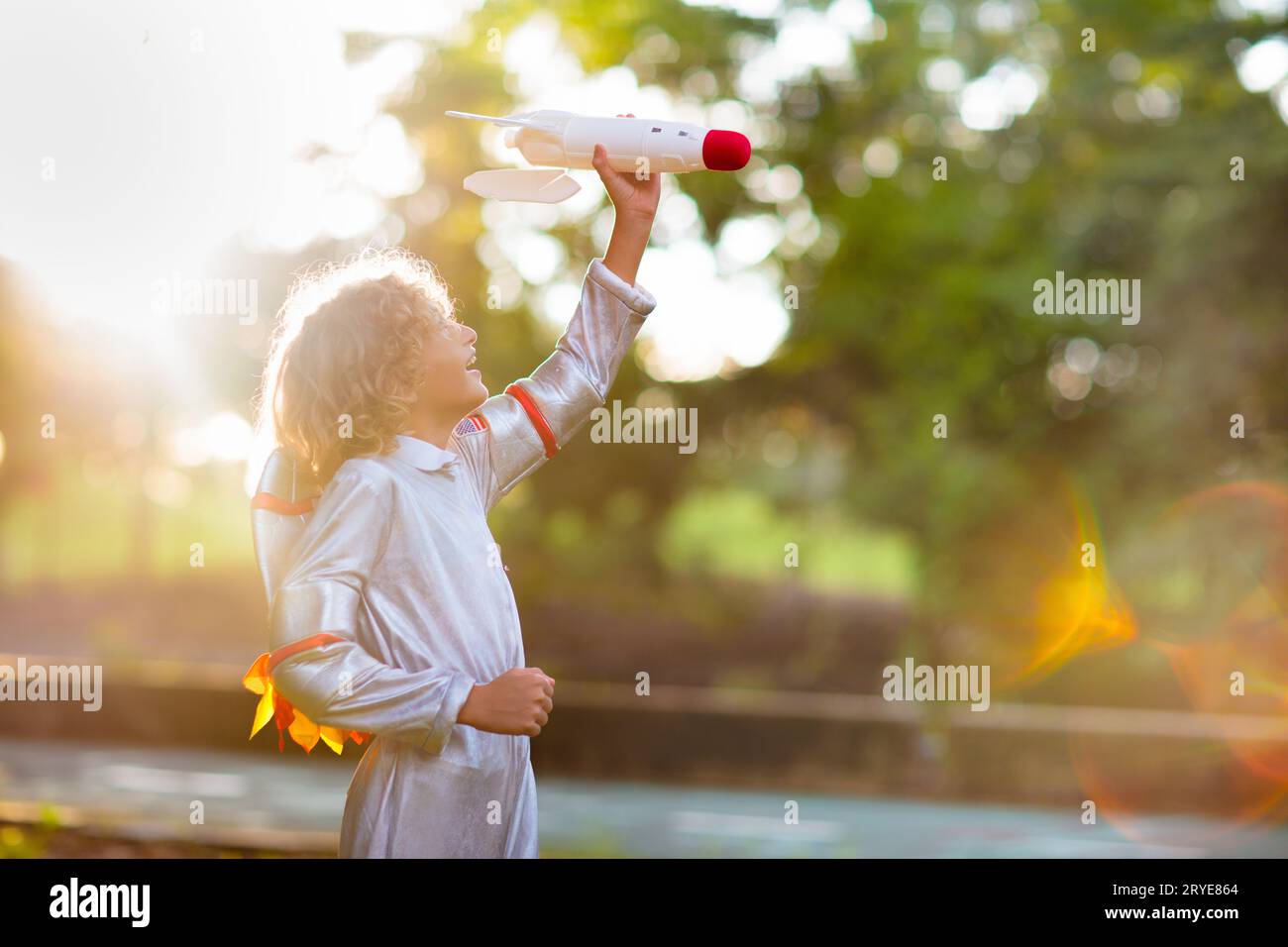 Little boy playing with spaceship. Astronaut costume for Halloween ...