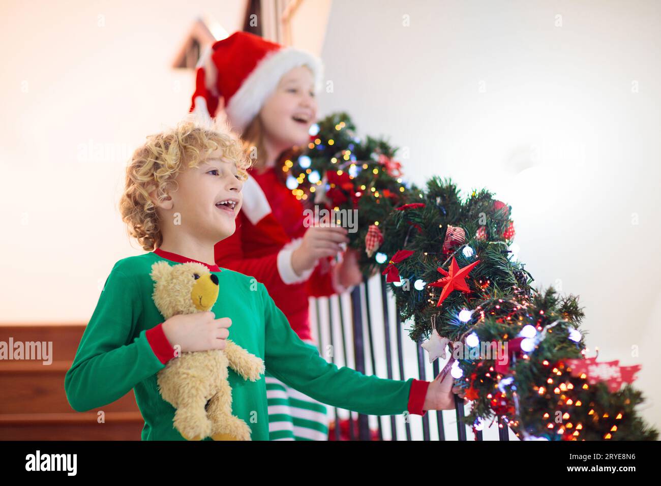 Kids running stairs on Christmas morning. Children in pajamas run ...