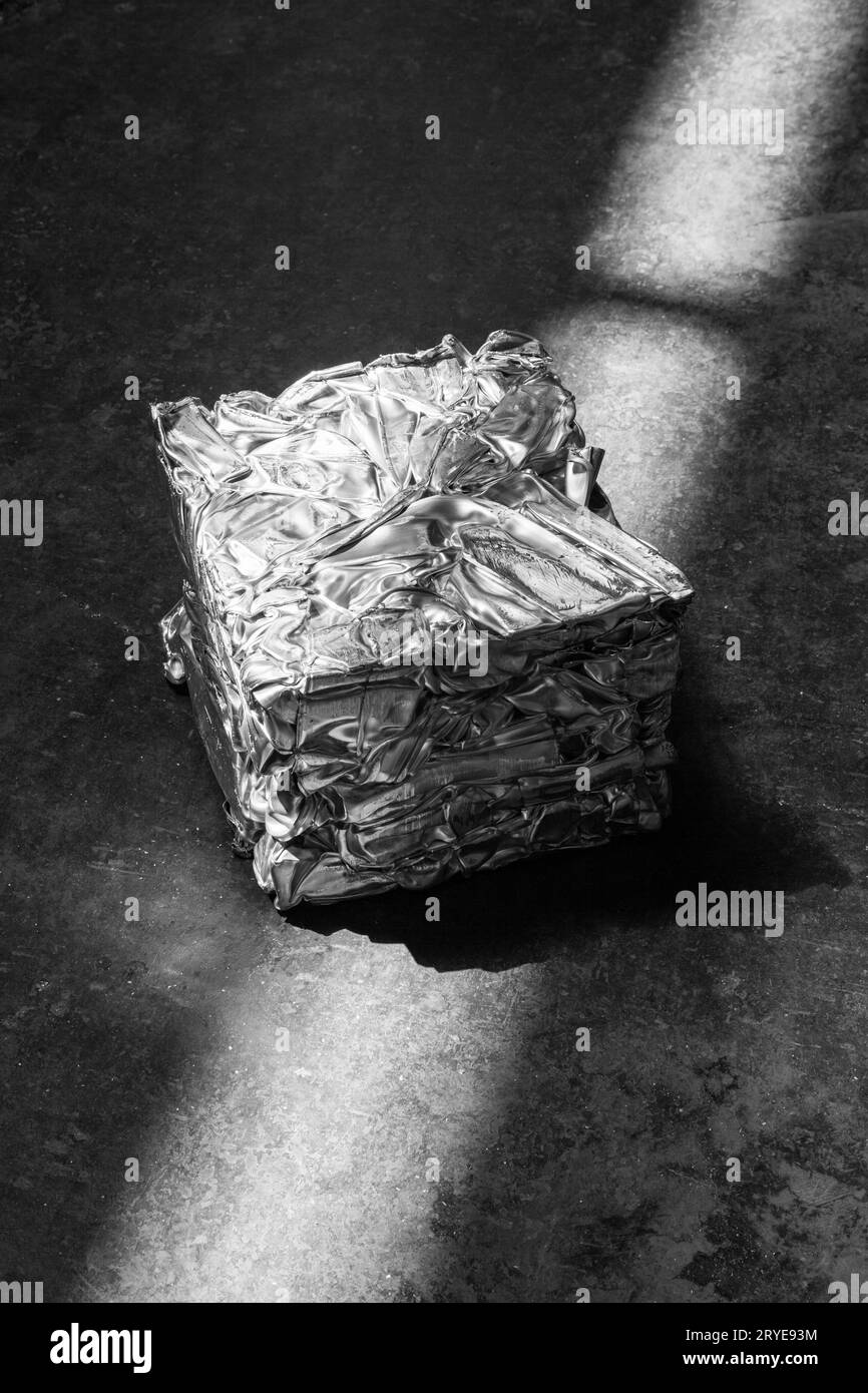 Pressed into a cube piece of metal Stock Photo - Alamy