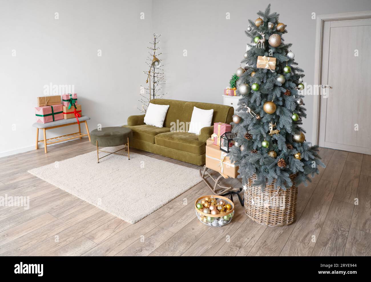 Interior of living room with sofa and Christmas tree Stock Photo - Alamy
