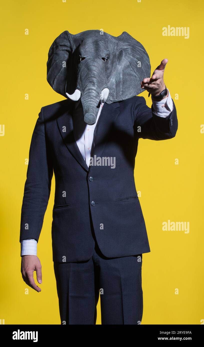 Man with an elephant mask on a yellow background Stock Photo - Alamy