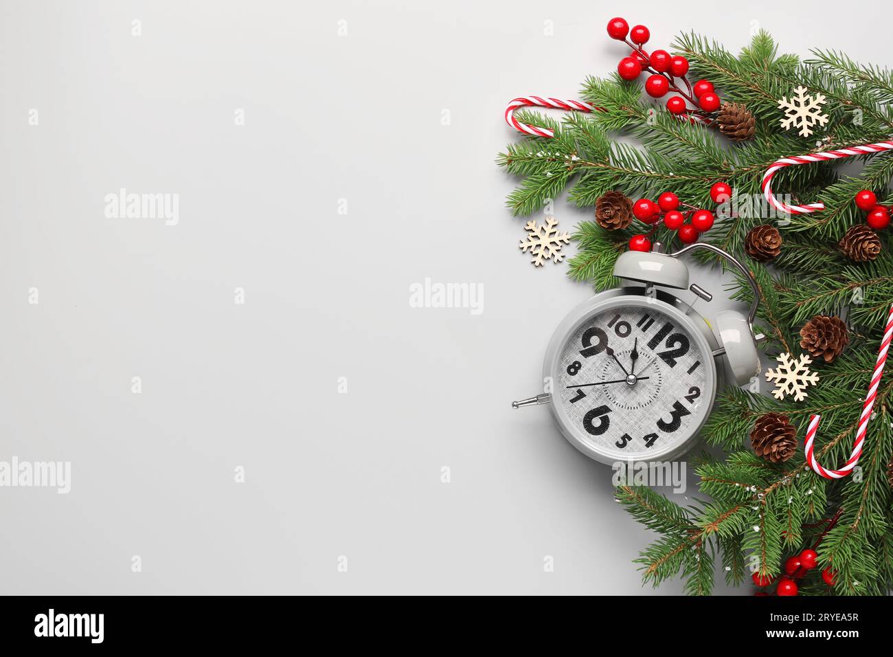 Alarm clock and candy canes, Christmas tree branches with beautiful ...