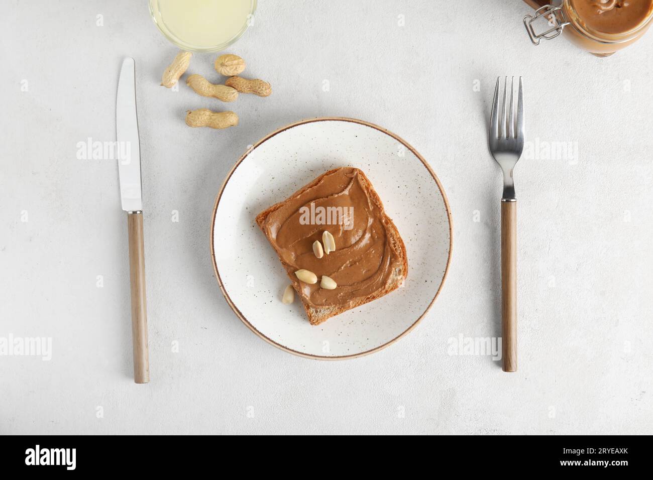 Plate of toast with peanut butter and nuts on white background Stock ...