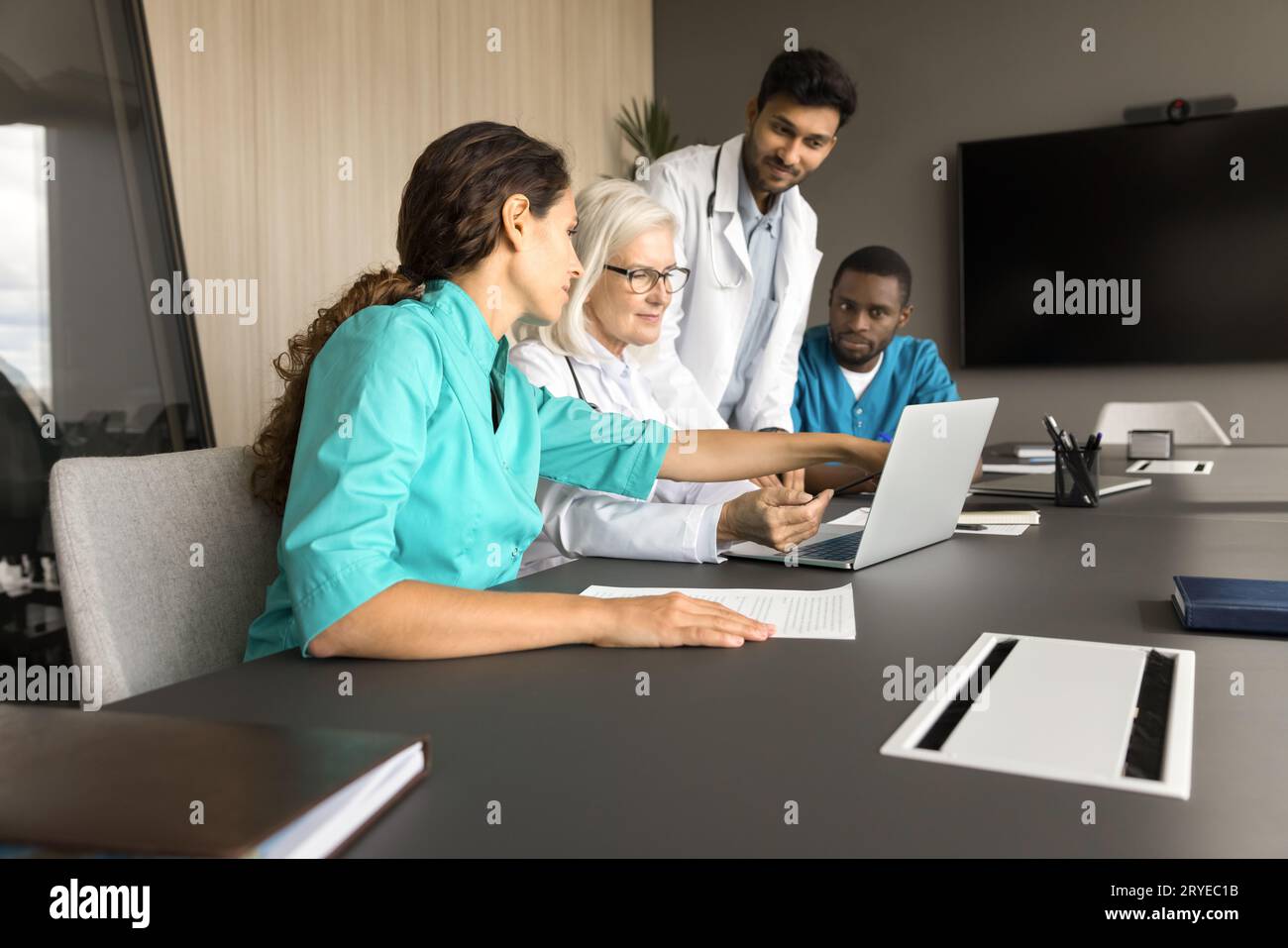 Multiethnic team of medical colleagues discussing healthcare technology ...