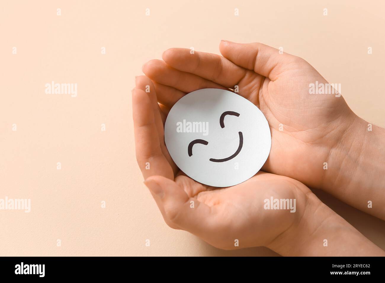 Female hands with happy smile face on beige background. Mental Health ...