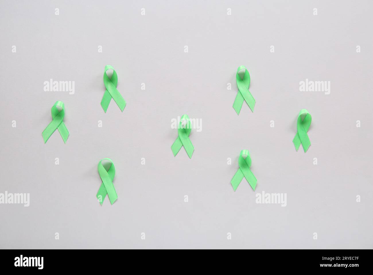 Green awareness ribbons on grey background. Mental Health Day Stock ...