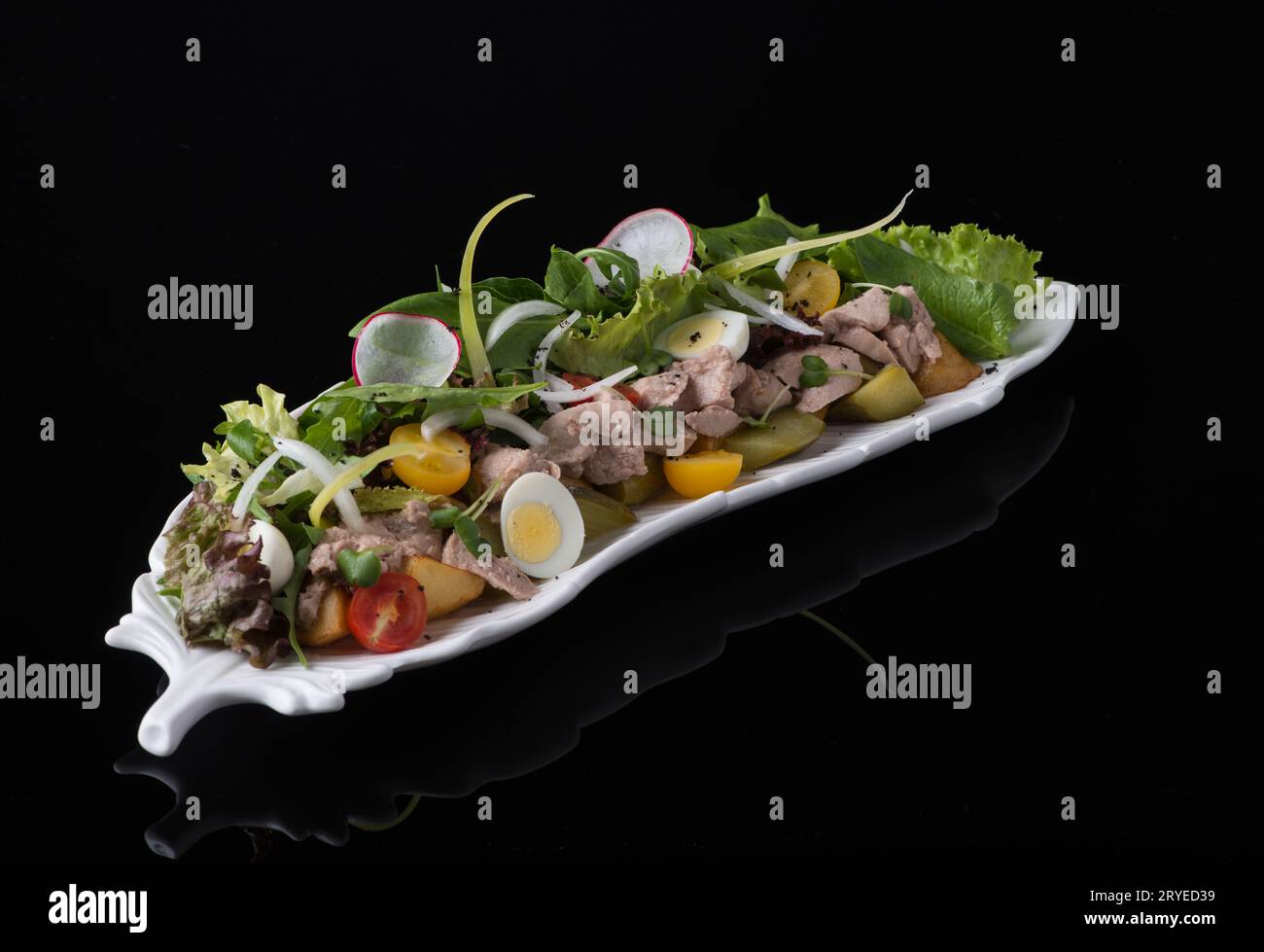 Dish on black background Stock Photo - Alamy