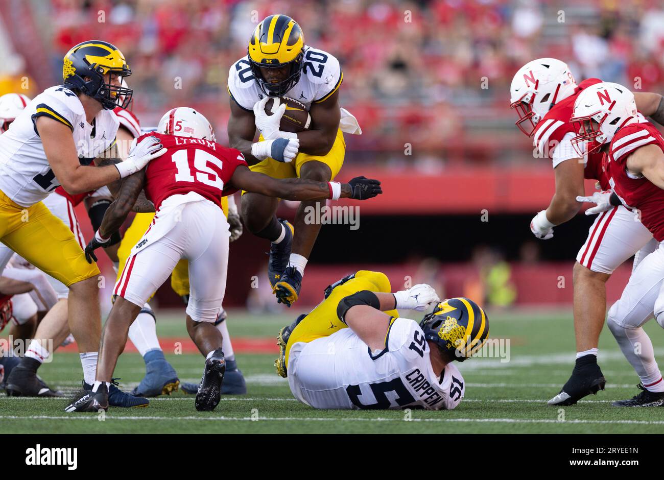 Michigan's Kalel Mullings (20) rushes against Nebraska's Tamon Lynum (15) during the second half ...