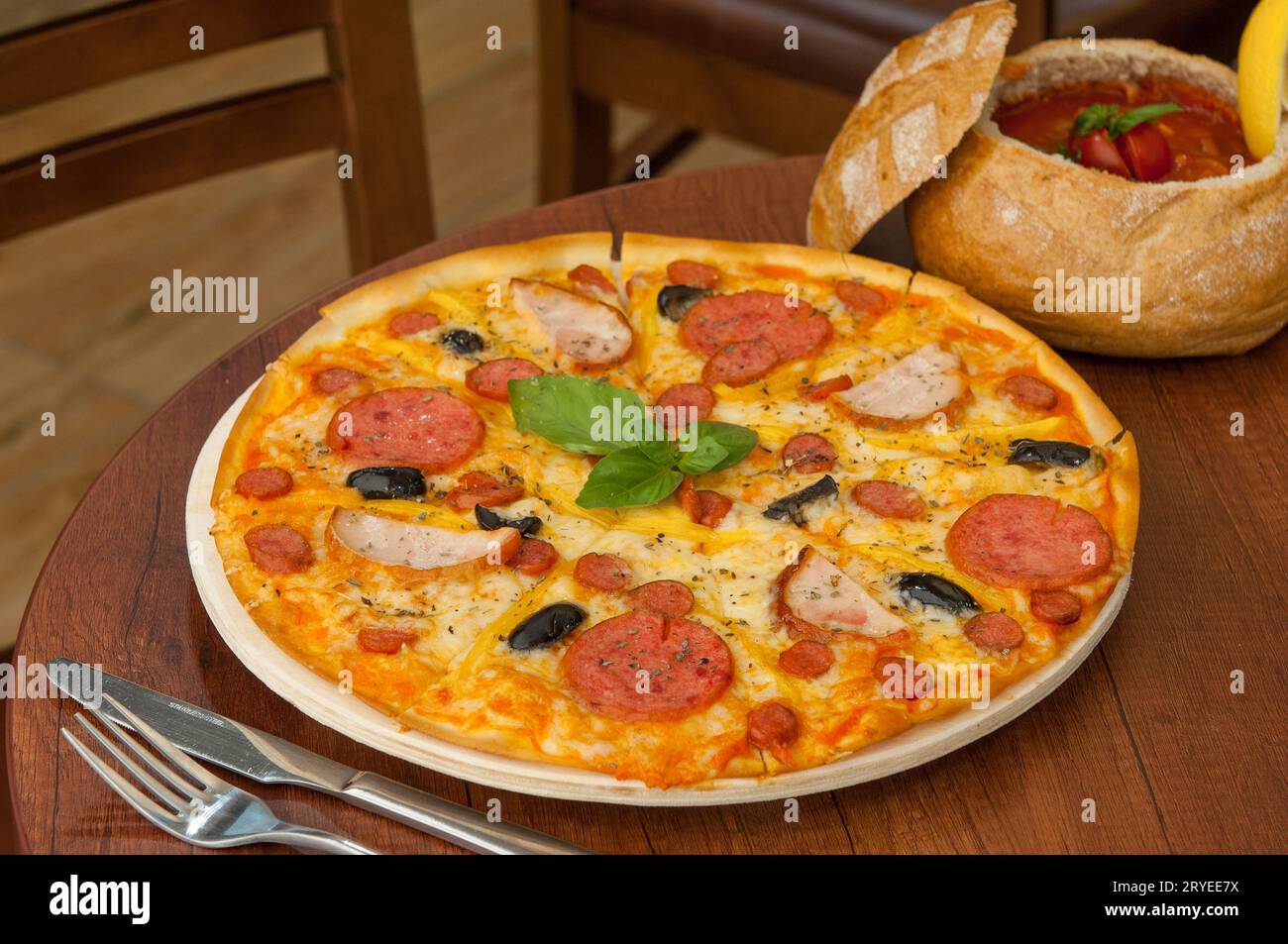 Pizza on the kitchen table Stock Photo - Alamy