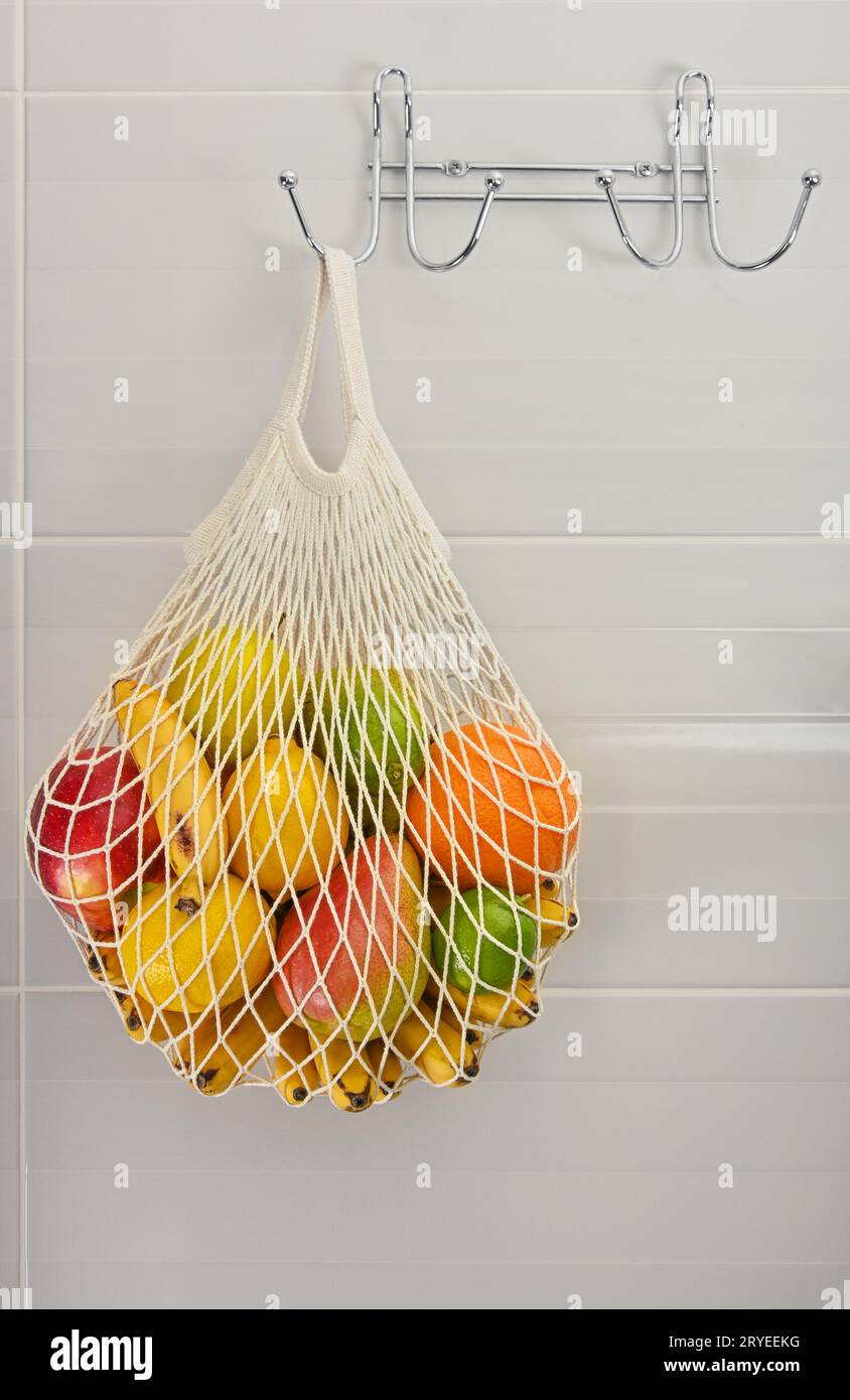 Assorted fresh fruits in string shopping bag Stock Photo - Alamy