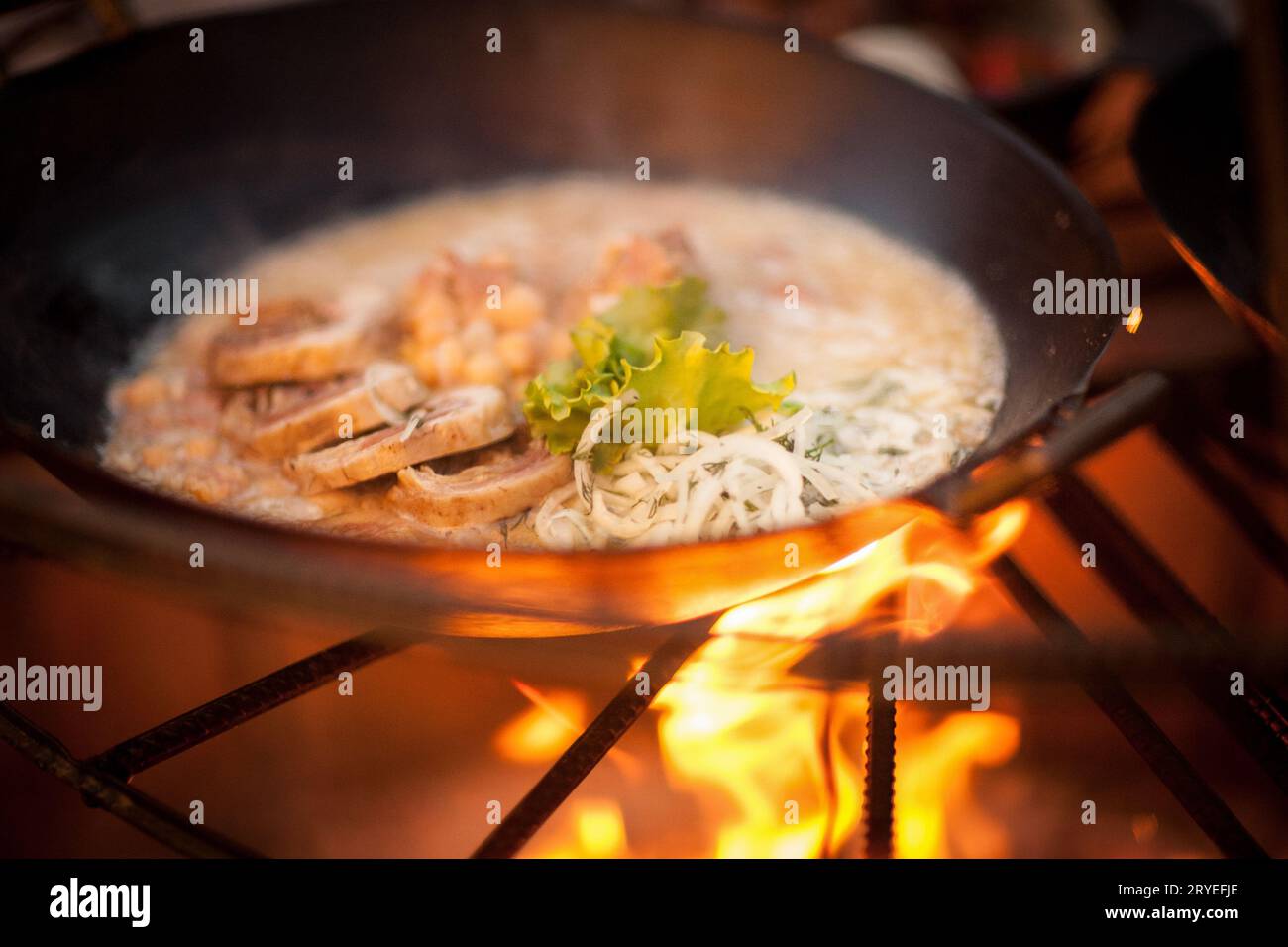 Cooking on fire Stock Photo - Alamy
